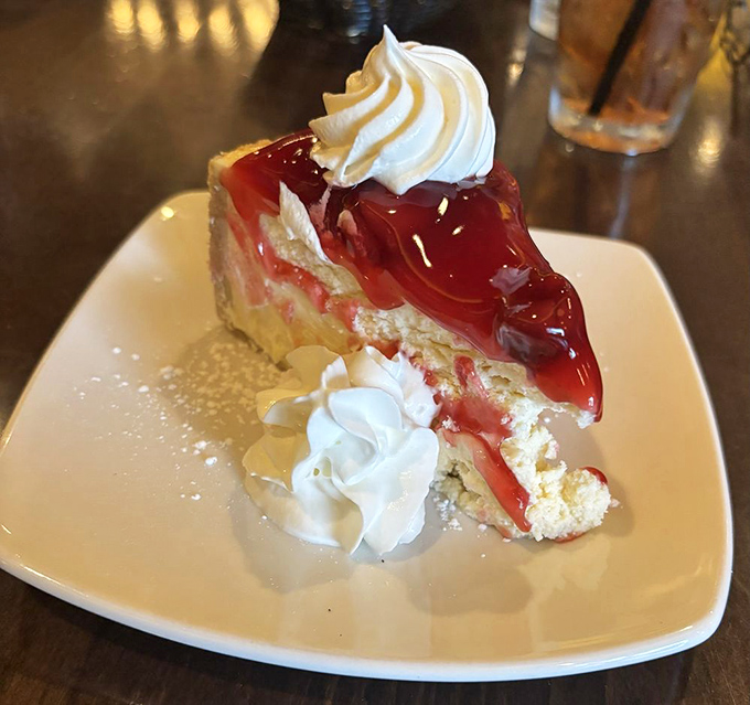 Cherry cheesecake that strikes the perfect balance between sweet and tart, topped with a dollop of whipped cream that's practically begging for a close-up.