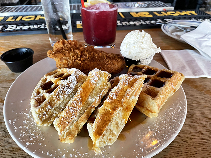 Chicken and waffles: the culinary equivalent of a perfect marriage. The powdered sugar dusting adds that touch of sweetness that ties everything together.