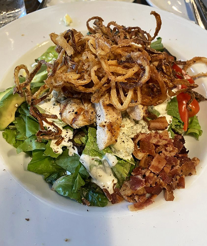 A salad that doesn't feel like punishment. Those crispy onion strings on top are the crown jewels in this kingdom of greens.