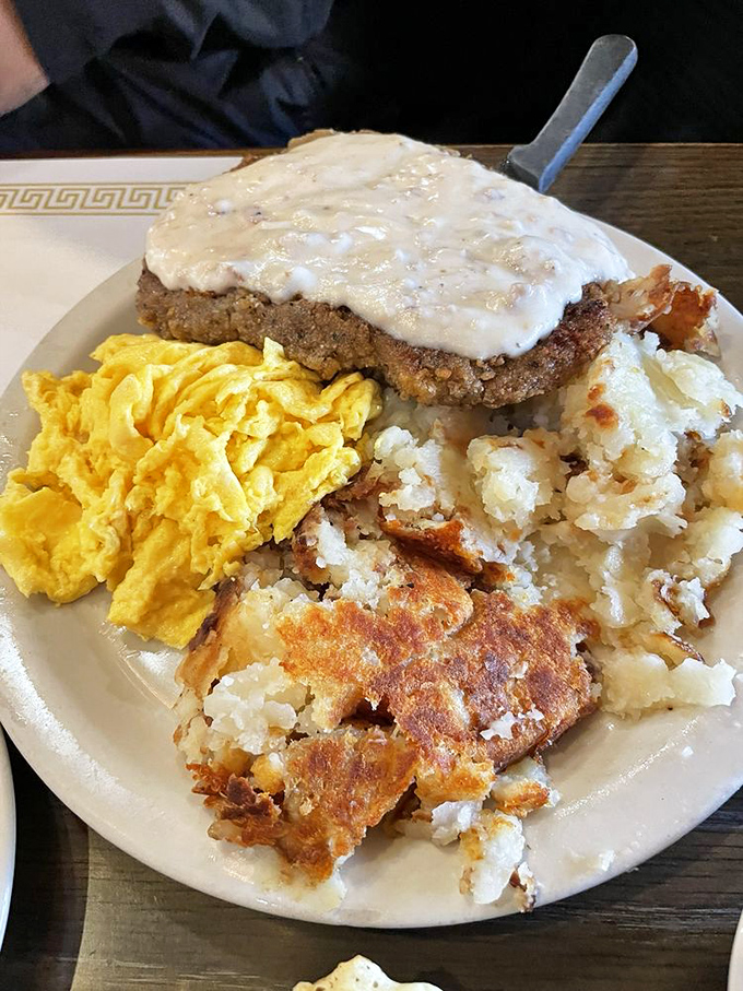 Chicken fried steak smothered in country gravy with eggs and potatoes—the breakfast equivalent of a warm hug from your favorite aunt.
