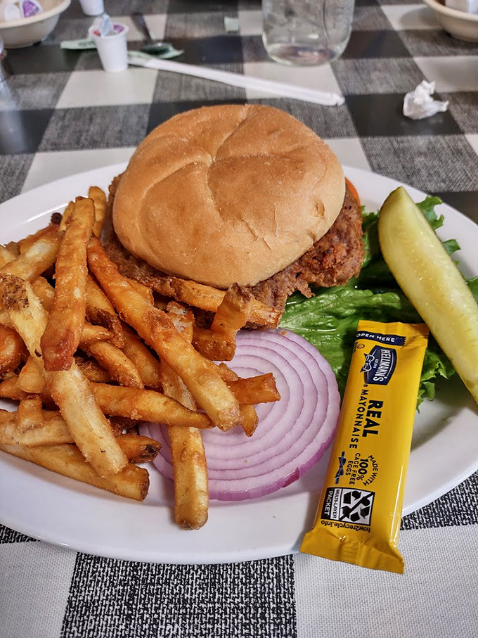 A proper diner burger doesn't need fancy aioli or artisanal buns&mdash;just honest ingredients, crispy fries, and that pickle spear standing at attention.
