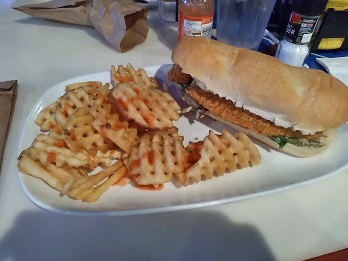 A chicken sandwich dressed with waffle fries that look like they're auditioning for a supporting role.