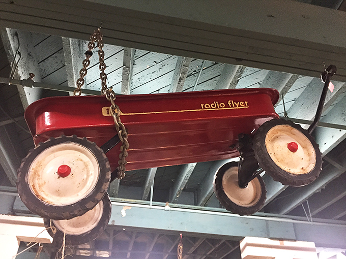 That Radio Flyer wagon hanging from the ceiling isn't just transportation; it's childhood summers, skinned knees, and neighborhood adventures.