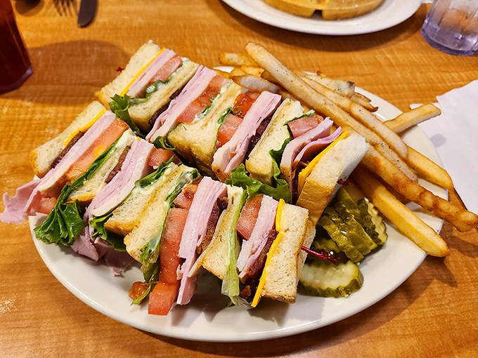 The club sandwich&mdash;three stories of deli perfection with a side of fries. Architecture you can eat, engineered by someone who understands hunger.