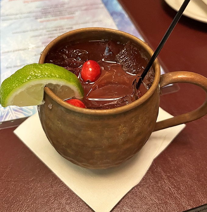 A Moscow Mule that knows how to dress for the occasion&mdash;copper mug, lime wedge, and those cherries adding a pop of color like tasteful jewelry.