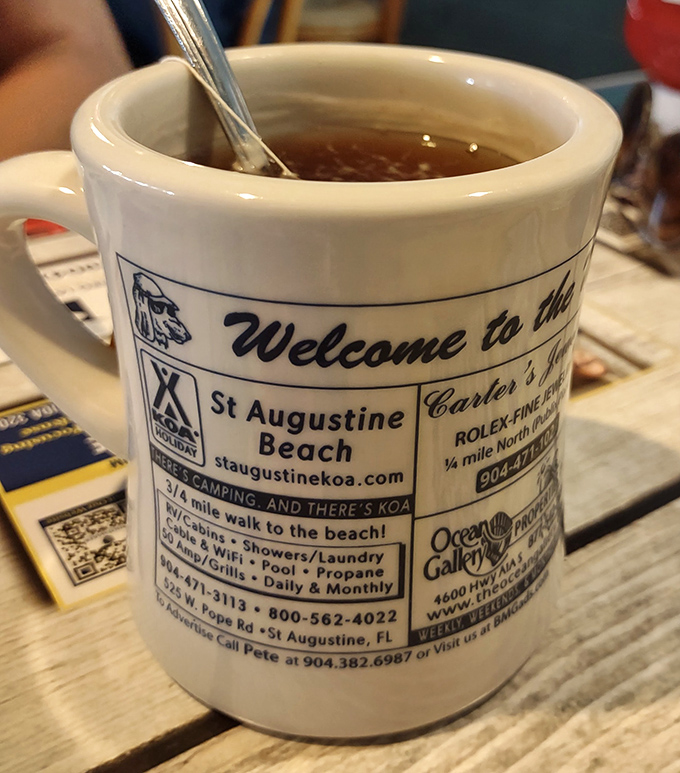 Coffee served in a mug that doubles as a St. Augustine Beach souvenir &ndash; multitasking at its finest.