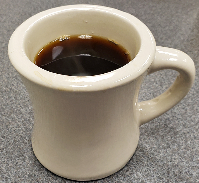 This sturdy white mug of coffee doesn't need fancy latte art&mdash;it's here to do a job, and that job is getting you through vacation mornings with caffeinated authority. 