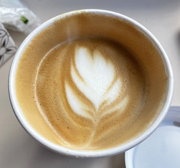 Coffee art so pretty you almost feel guilty destroying it. Almost. The caffeine beckons with promises of alertness and joy.