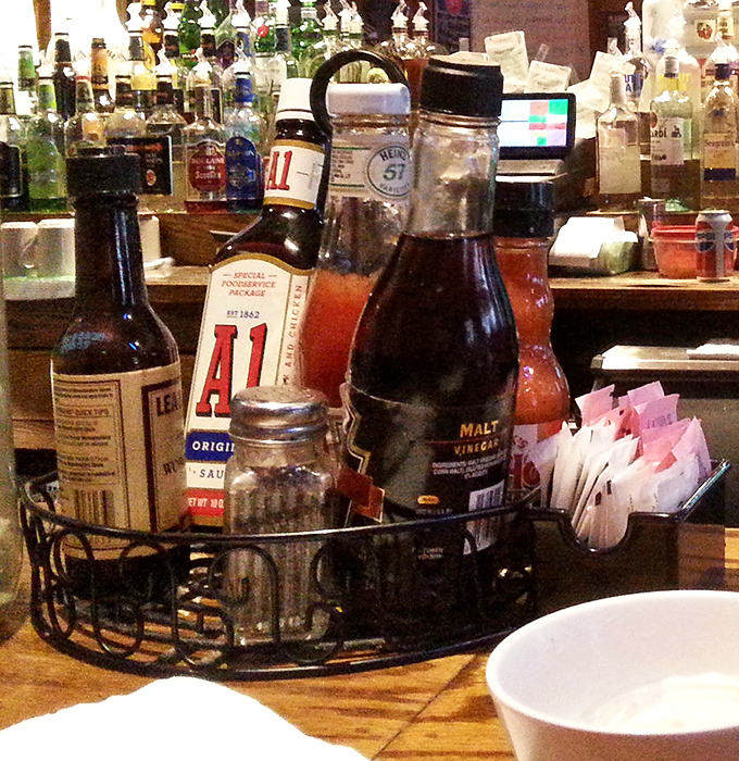 That condiment caddy is like a spice library for your burger&mdash;A1 and malt vinegar standing by for emergency flavor deployment.