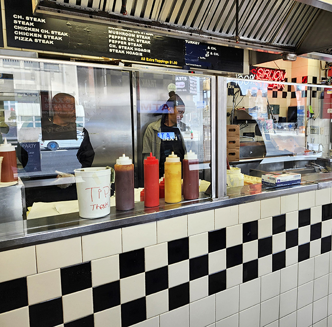 The condiment lineup stands ready for duty. Those squeeze bottles have seen more action than a Hollywood stuntman.