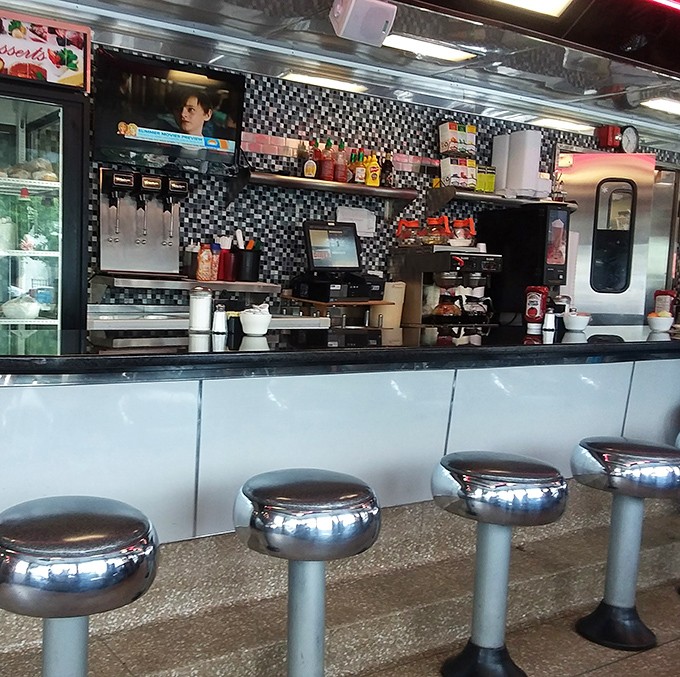Chrome stools lined up like soldiers, ready for the next shift of hungry patrons to perch and ponder life's big questions over small plates.