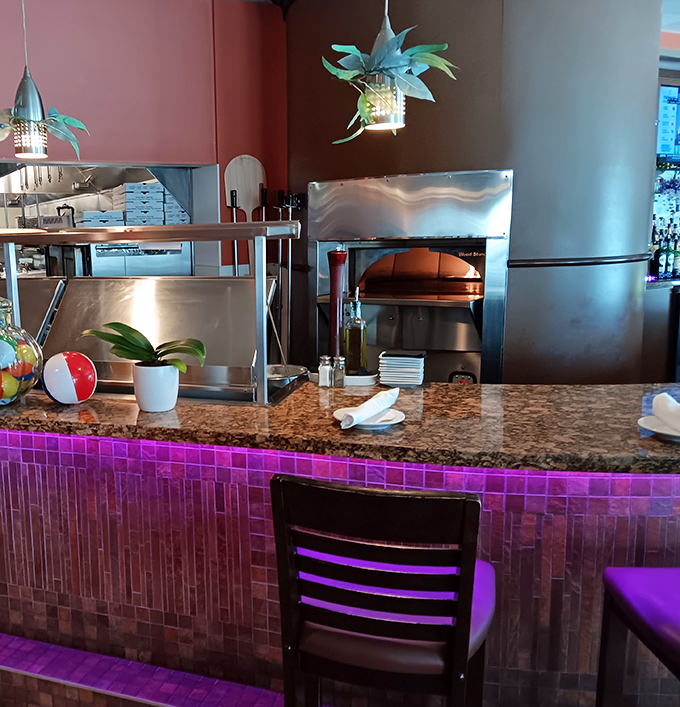 Counter seating offers front-row views of the pizza oven where magic happens daily.