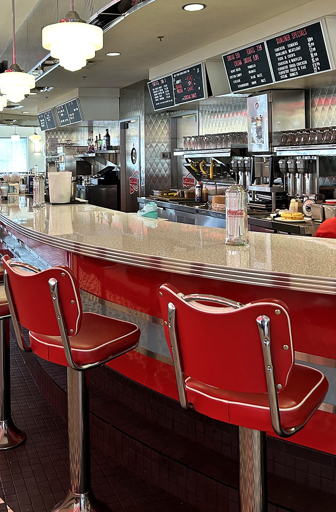 Red vinyl stools lined up at the counter like soldiers at attention, ready for solo diners seeking both nourishment and neighborly conversation.