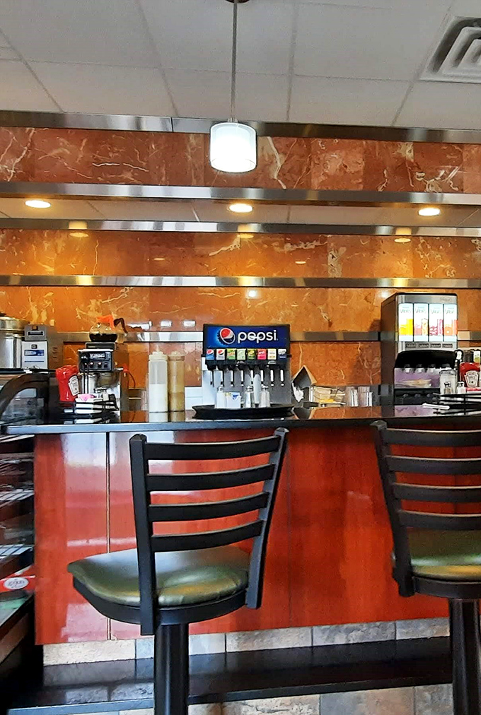 The counter area gleams with that distinctive diner polish, where solo diners find community and regulars debate everything from politics to pie selection with equal passion.