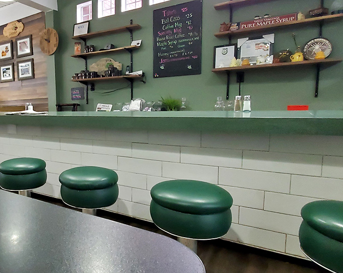 Counter seating that invites conversation with strangers who become friends over coffee. The green stools have witnessed more local gossip than any newspaper column.