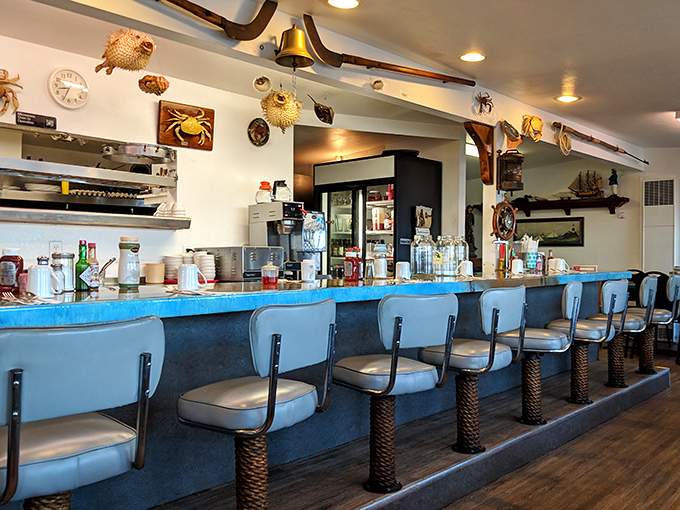 The counter's blue charm and rope-wrapped stools invite solo diners to perch and watch the kitchen magic unfold beneath an array of mounted sea creatures.