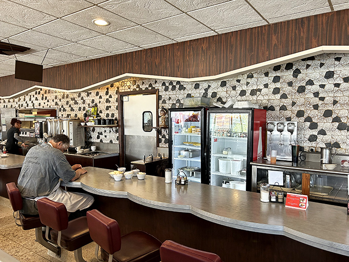 Black and white mosaic meets classic counter culture. The curved lunch counter&mdash;where solo diners find community over coffee.