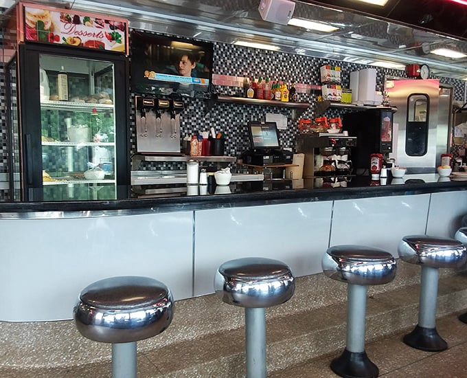 The counter—where solo diners become temporary family. Those gleaming stools have witnessed more life stories than a bestselling memoir.