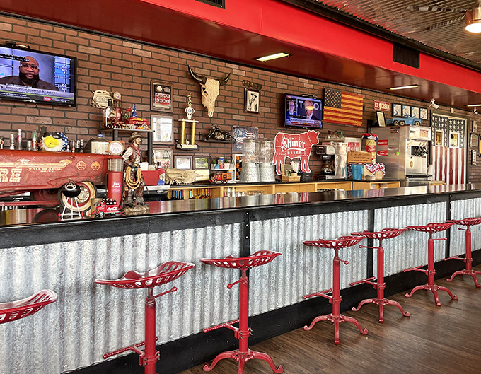 The counter seating area &ndash; where BBQ aficionados can watch the magic happen while perched on those distinctive red tractor-style stools. Front row to flavor town.