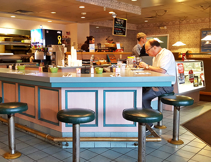 The counter seating offers front-row tickets to the breakfast ballet, where regulars find comfort in both the food and familiar faces behind it.