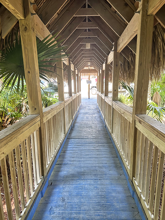 The covered walkway feels like a tropical tunnel transporting you from ordinary life to beachfront bliss with every wooden plank.