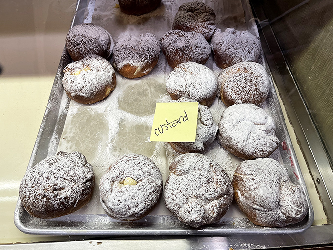 Custard-filled donuts dusted with powdered sugar, looking like clouds you can actually taste and enjoy.