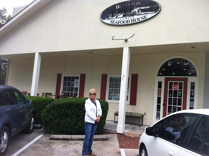 One happy customer proving that good seafood creates smiles more genuine than any Instagram filter could manage.