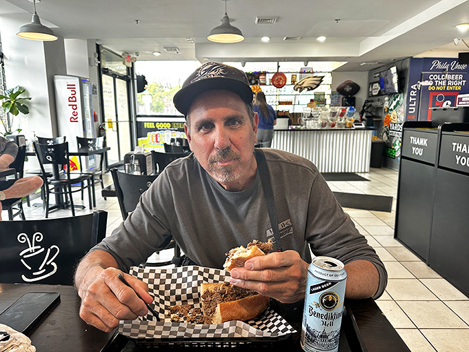 Every great sandwich deserves an appreciative audience. This deli regular knows the proper cheesesteak-to-beer ratio is serious business.
