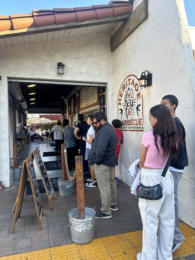 The line forms early for a reason. These patient pilgrims understand that great barbecue, like true love, is worth waiting for.