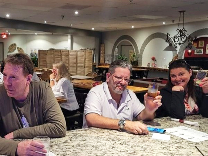 Happy customers raising glasses – the universal sign that you've found a place worth returning to repeatedly.