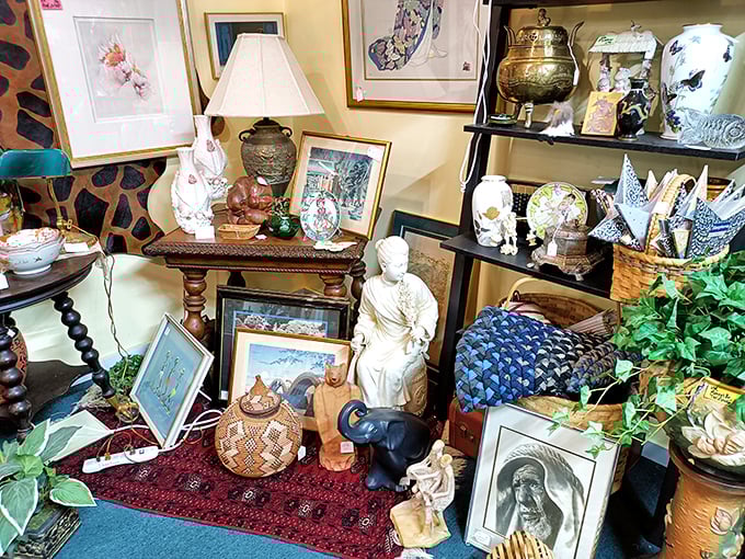 The corner where eclectic meets elegant. That Mother Teresa portrait sharing space with ceramic rabbits somehow makes perfect sense in the antique universe.