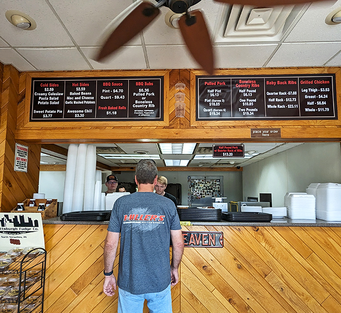 A glimpse into barbecue headquarters, where smoke-masters work their magic. The menu board silently judges those who order anything less than "a lot."