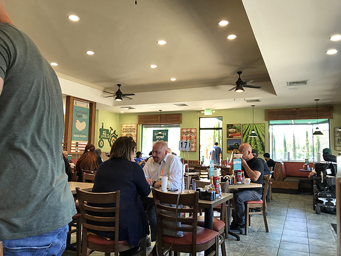 Where strangers become neighbors over coffee and eggs. The bustling dining room captures that perfect community restaurant energy.