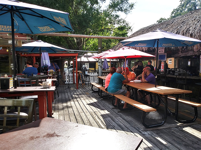 Under the thatched roof, strangers become neighbors, sharing stories across the bar while waiting for their grouper sandwiches.