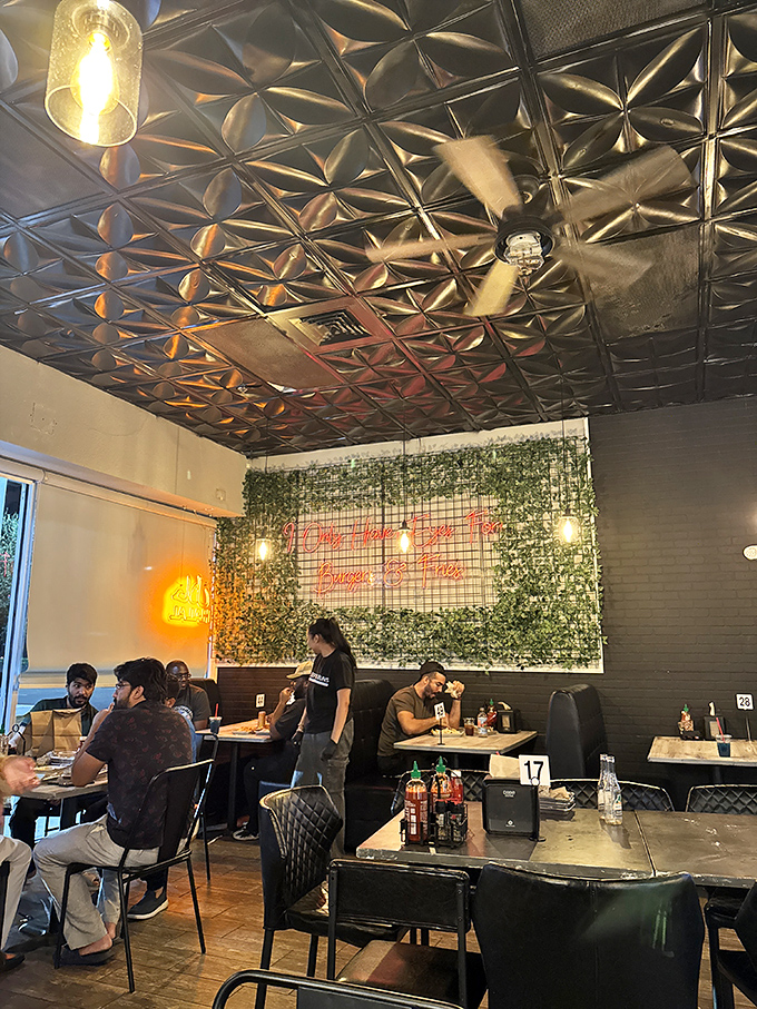 A living wall adds a touch of greenery to the industrial-chic space where food and conversation flow equally well.