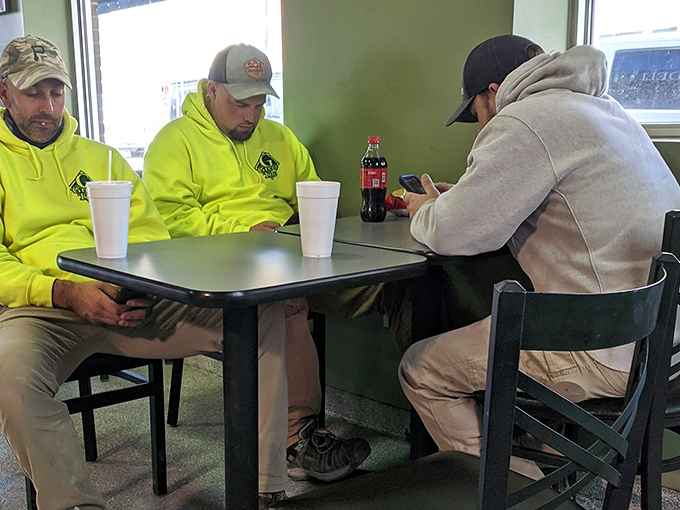 Working men taking a lunch break &ndash; in the universal language of sandwich appreciation, no translation is necessary.