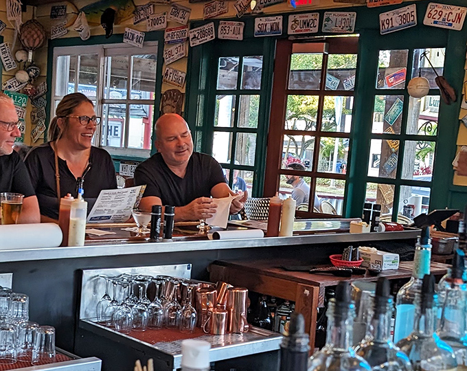 Where laughter meets license plates. The bar area isn't just for drinking&mdash;it's where strangers become friends over stories and seafood.