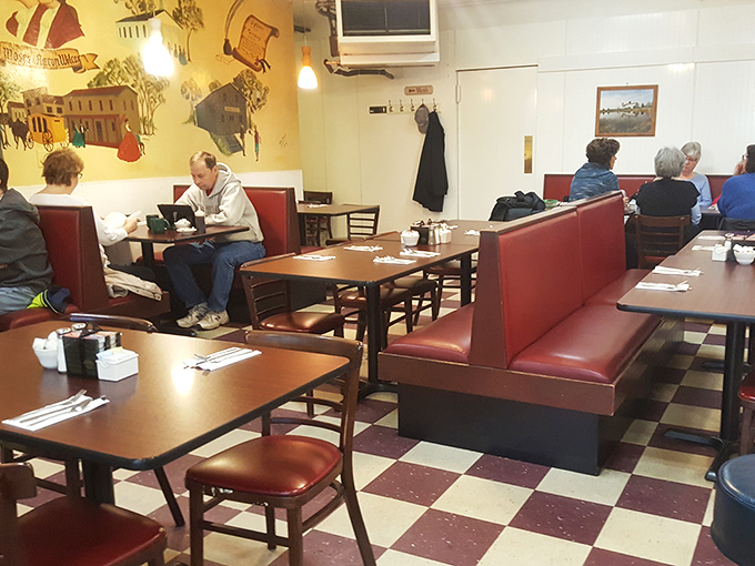 Morning rituals playing out in red vinyl booths. Some read, some chat, all united by the universal language of good food.