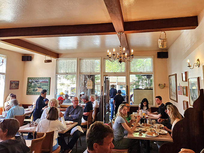 A bustling dining room where strangers become temporary breakfast companions, united by the universal language of "pass the syrup, please."