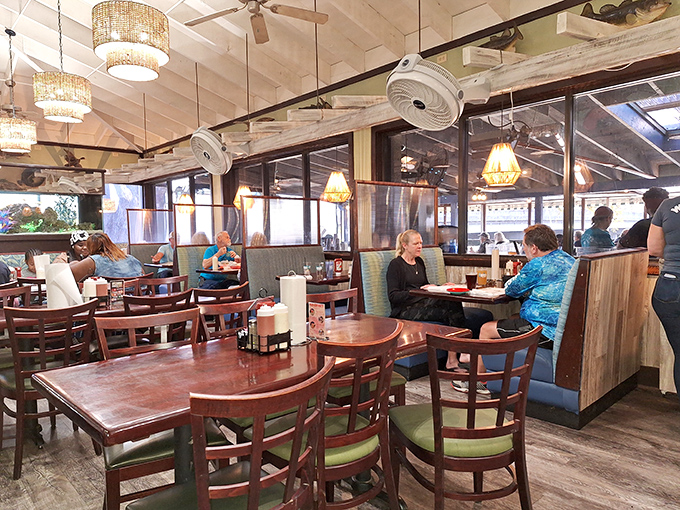 Locals and visitors alike gather in this dining sanctuary where conversations flow as freely as the nearby creek.