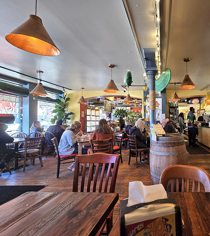 Pendant lights cast a warm glow over diners deep in conversation and deeper in sandwich bliss&mdash;the universal language of good food.