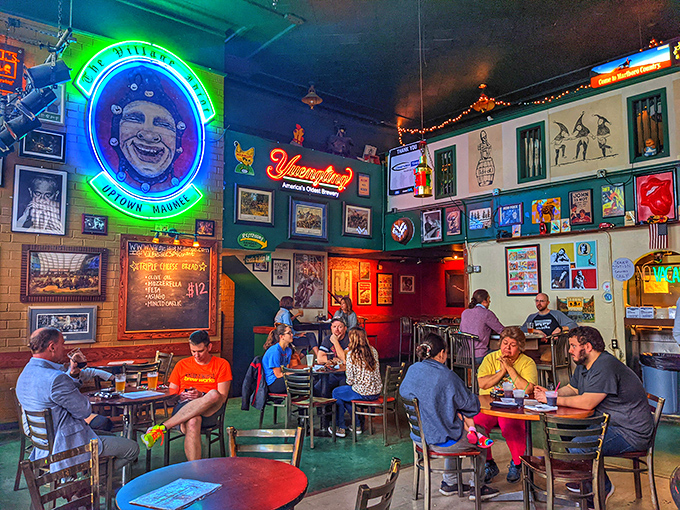 The daytime crowd proves great pizza knows no hour. That neon jester watches over patrons like a grinning guardian of good times.