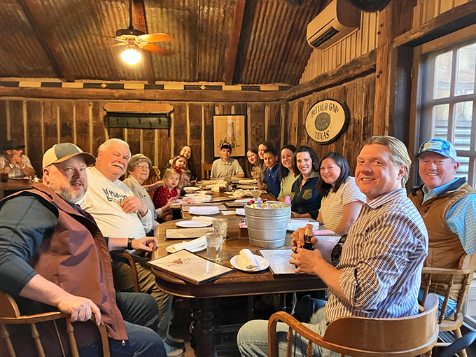 Happy diners gathered around a table laden with Texas-sized portions &ndash; this is what food memories are made of.