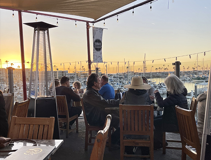 Sunset dining on the patio where the real show isn't on your plate but on the horizon, as golden hour transforms the harbor into a postcard.