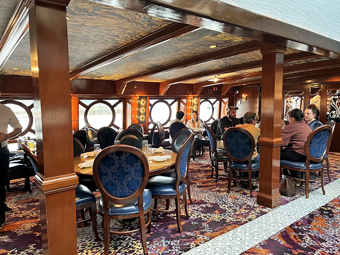 The dining room balances nautical heritage with modern comfort&mdash;those porthole windows aren't just design elements, they're time machines.