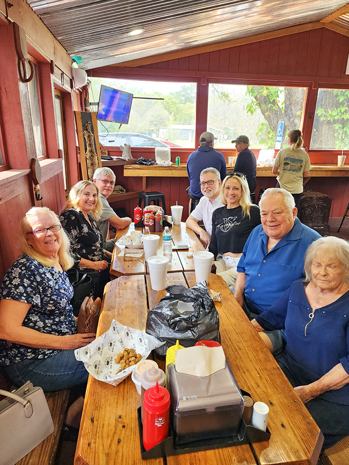 Happy faces around a picnic table&mdash;the universal sign of BBQ done right. No phones in sight, just people living in the moment, connected by smoke and sauce.