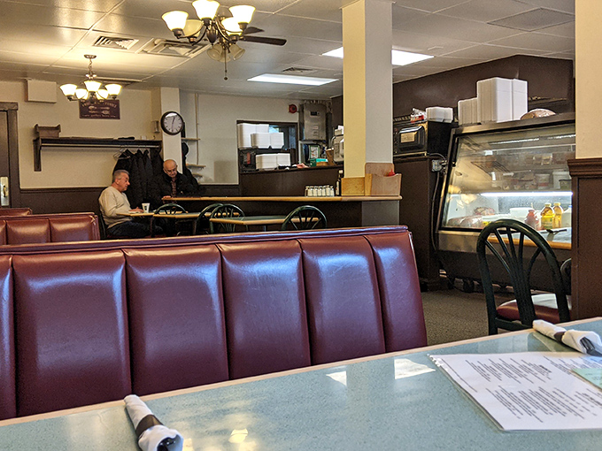 Red vinyl booths that have cradled countless conversations, from first dates to retirement plans and everything in between.