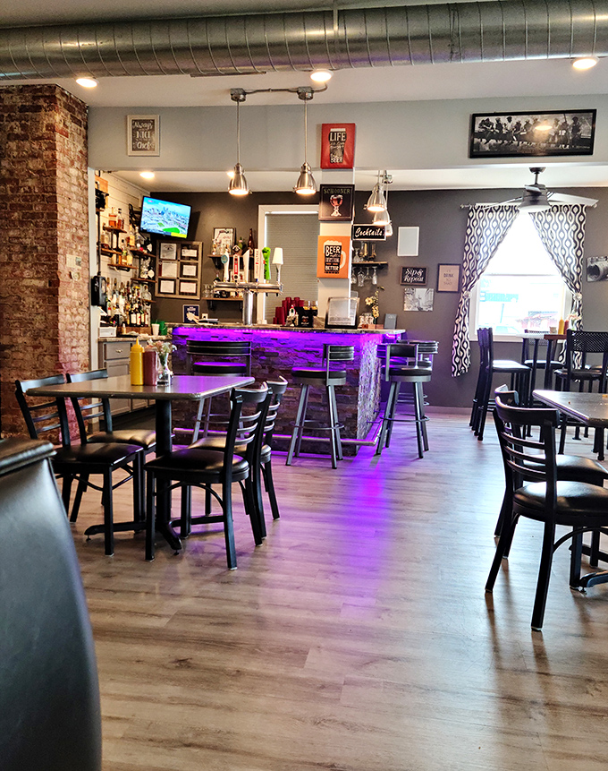 The bar area glows with purple ambiance, creating the perfect backdrop for evening conversations and inevitable food comas.