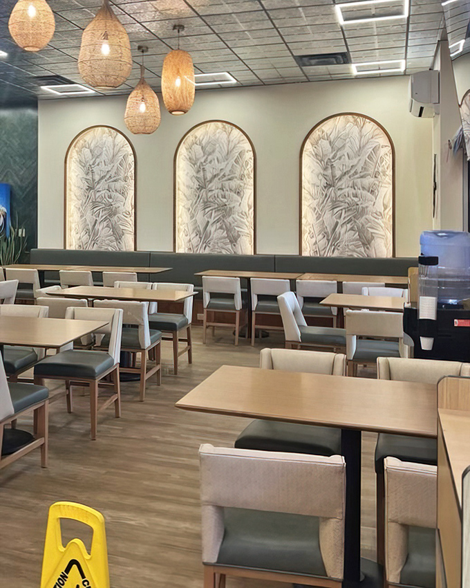 The dining room feels like a modern oasis with those distinctive pendant lights floating above like illuminated cocoons of hospitality. 