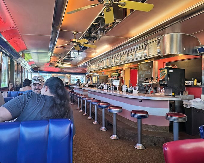 The classic diner layout: booths on one side, counter on the other, and conversations flowing as freely as the coffee.
